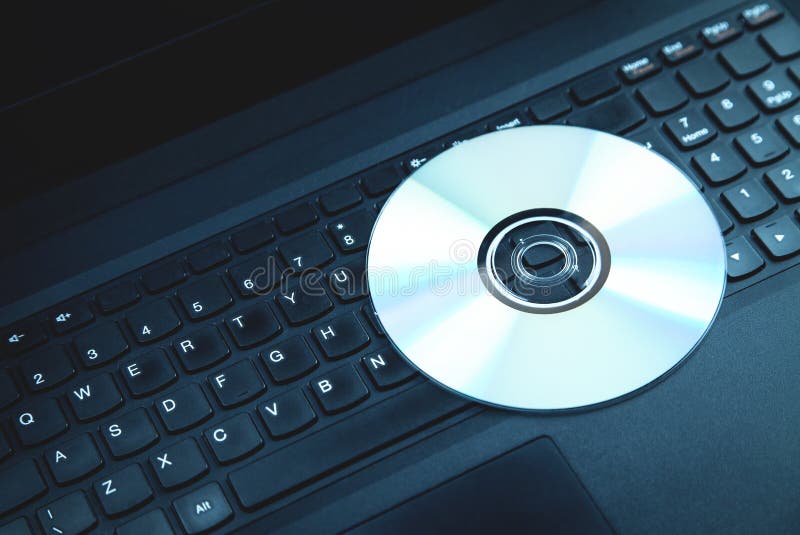 DVD Disk on the Laptop Keyboard Stock Photo - Image of digital, storage ...