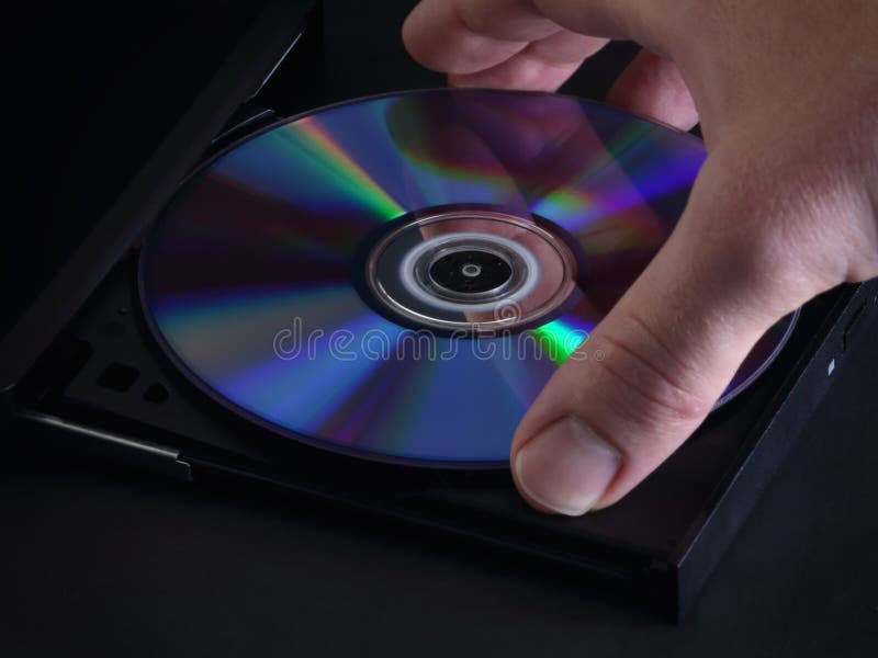 DVD Loading into a Disc Player by Hand Stock Photo - Image of home ...