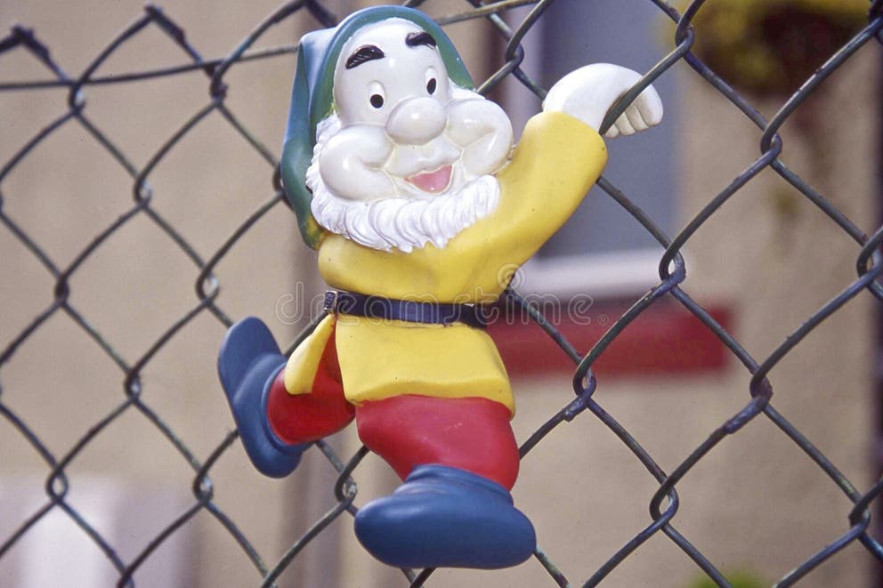 Dwarf hanging from a fence editorial stock image. Image of garden ...