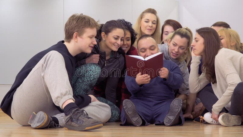 The Dwarf Reading the Book and Sits among the Friends on Floor Stock ...