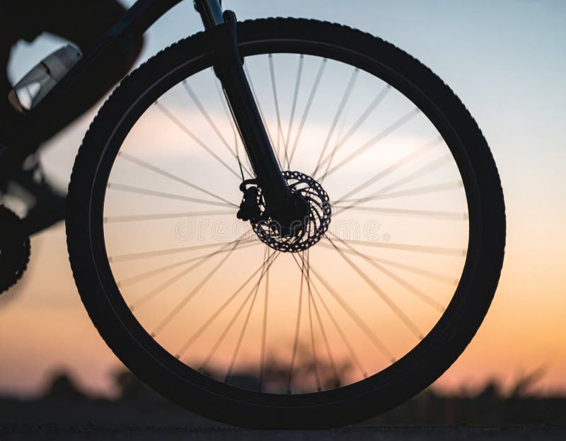 Dynamic Bicycle Wheel Silhouette Against a Vibrant Sunset Sky Stock ...
