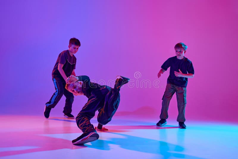 Dynamic Breakdance Show. Trio of Sreetdancers Performing in Motion in ...
