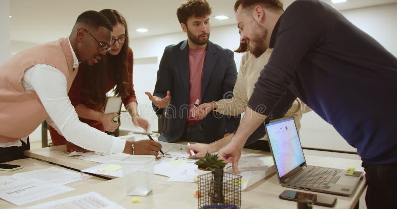 Dynamic Colleagues, Multi-ethnic and Collaborative, Work Late in a Modern Office, Discussing ...