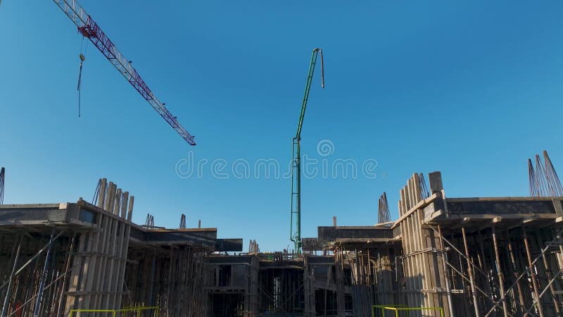 Aerial Video: Workers on Scaffolding Pouring Concrete on the Upper ...