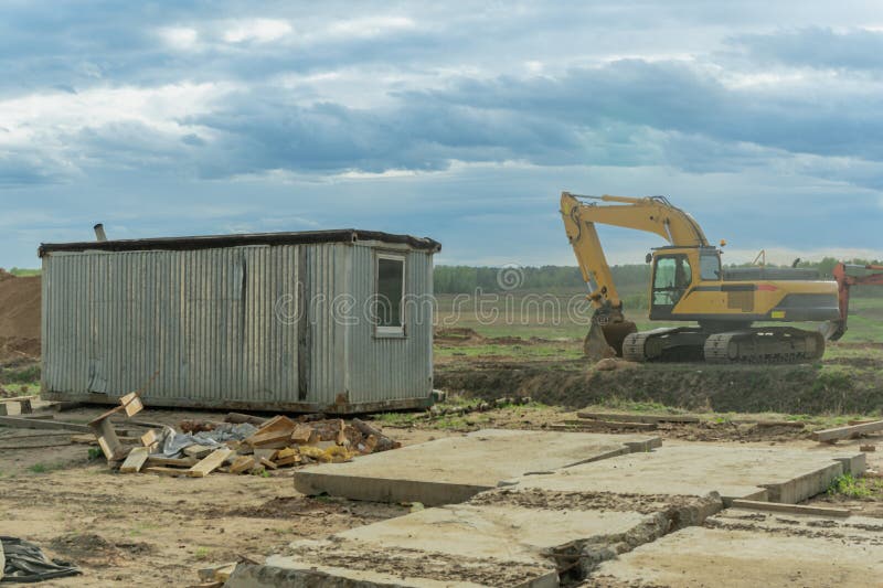 Dynamic Construction Site: Heavy Machinery in Action Under a Dramatic ...