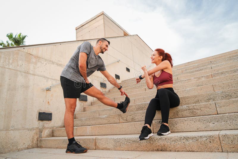 A Dynamic Couple Engaging in Stretching Exercises Together Enjoying ...