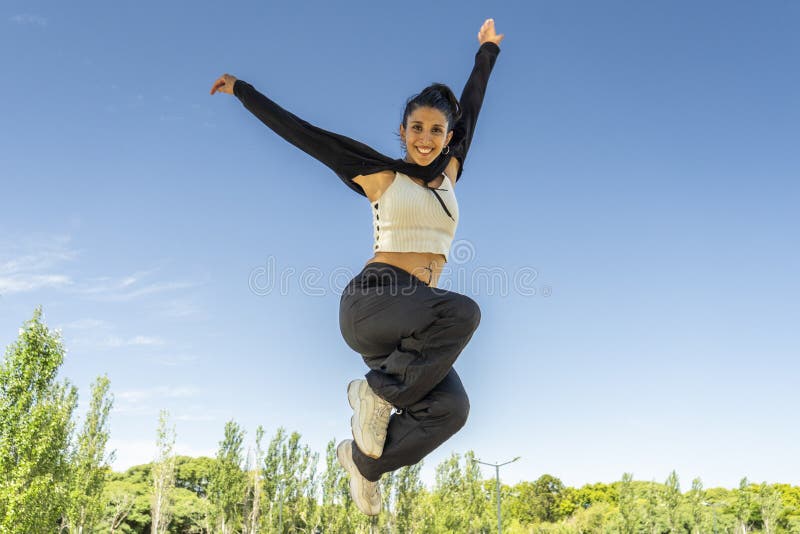 Dynamic Dance Jump by a Vibrant Urban Performer in the Park Stock Image ...