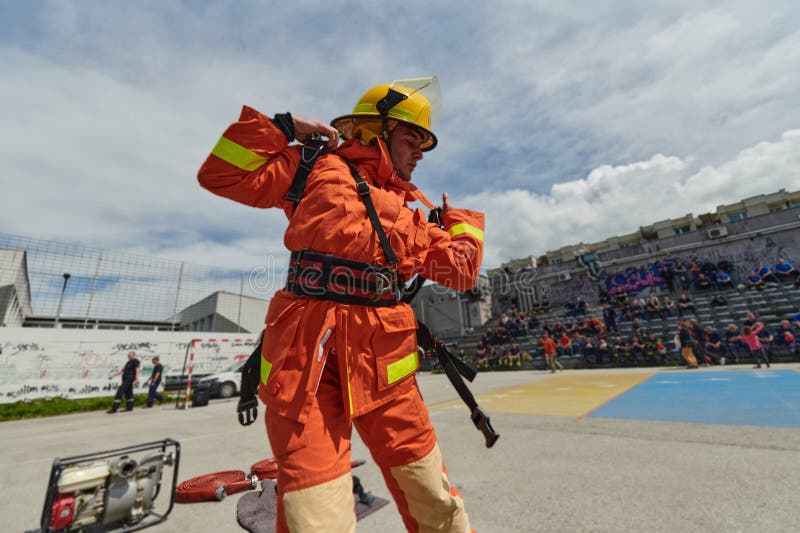In a Dynamic Display of Synchronized Teamwork, Firefighters Hustle To ...