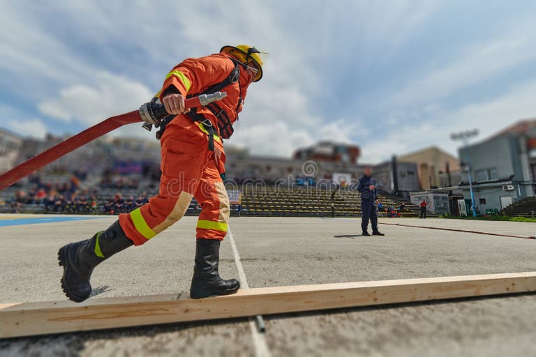 In a Dynamic Display of Synchronized Teamwork, Firefighters Hustle To ...