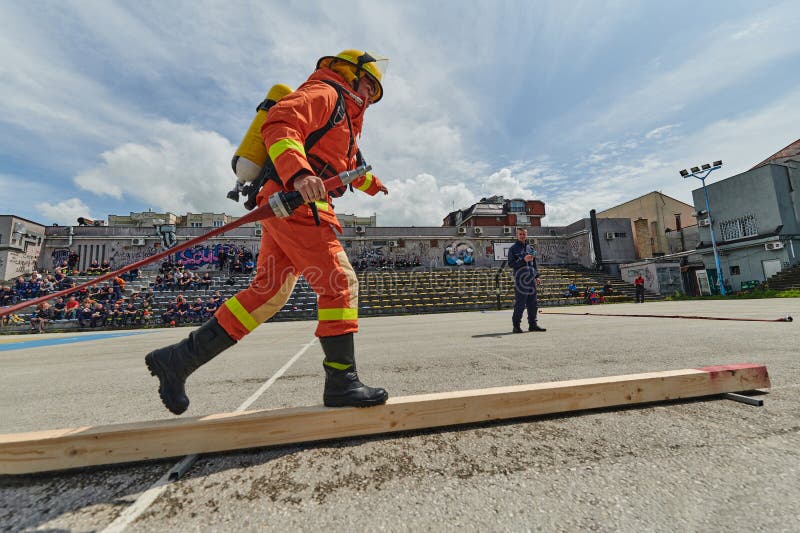 In a Dynamic Display of Synchronized Teamwork, Firefighters Hustle To ...