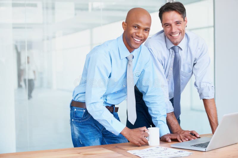 Dynamic Duo. Two Co-workers Smiling while Working in the Boardroom ...