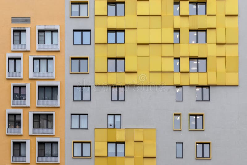 Dynamic Facade of a Building Featuring Yellow Panels and Windows for ...