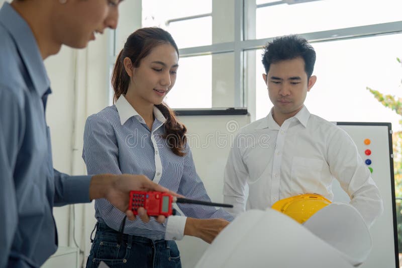 Construction Communication and Design. Professionals Discussing Detailed Project Plans and ...