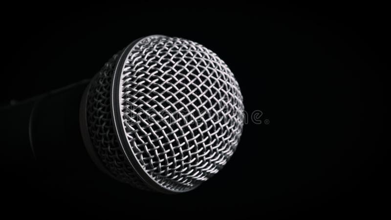 Dynamic Handheld Microphone Rotates on a Black Background Close-Up ...