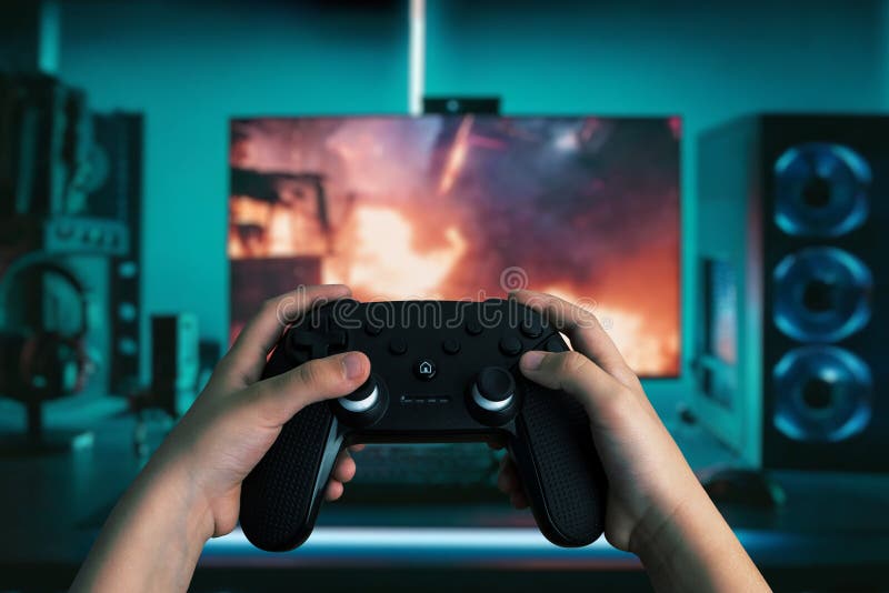 Dynamic Image of Hands Holding a Gamepad in Front of a Modern Gaming ...