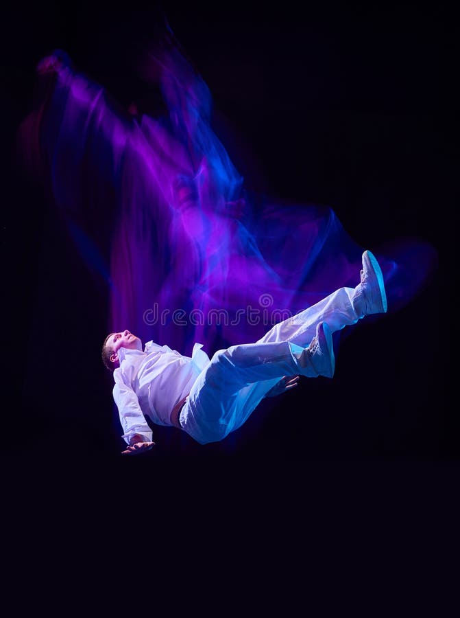 Dynamic Image of Young Man in Casual Clothes Falling Down Against Black ...