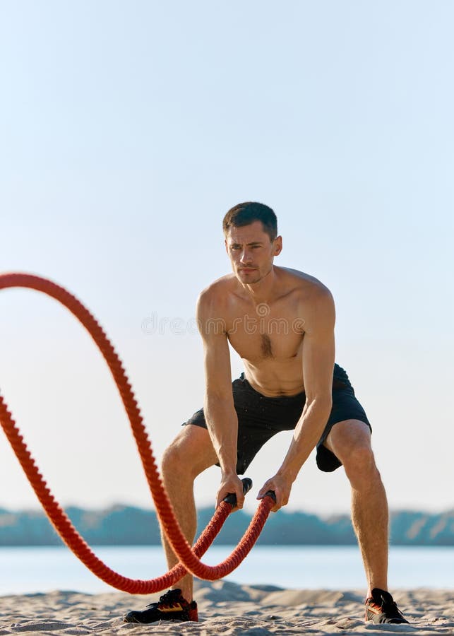 Dynamic Open Air Workout on Beach by the River. Muscular Athletic Man ...