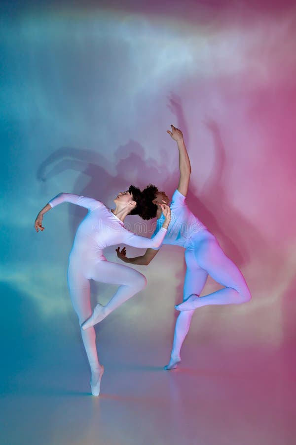 Dynamic Portrait of Two Ballet Dancers in White Leotards Expressing ...