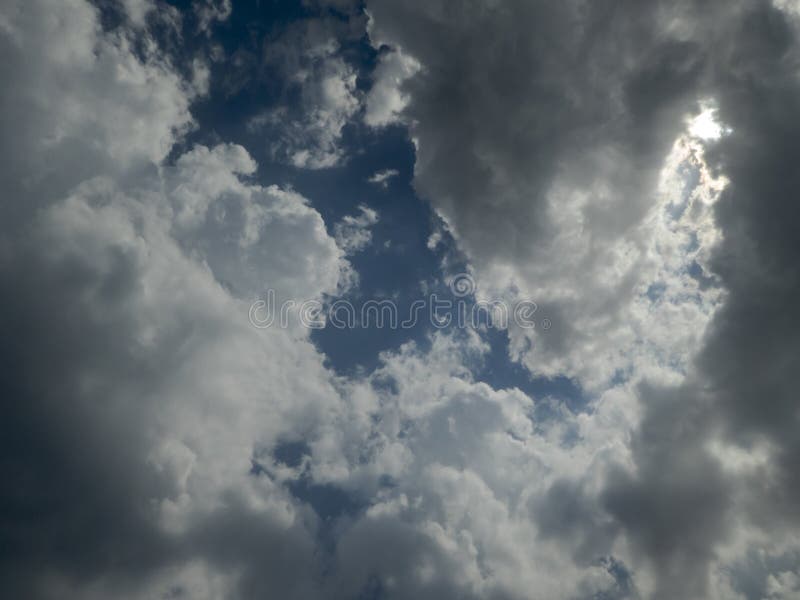 Dynamic Sky with Sun Peeking through Dark Clouds Stock Image - Image of ...