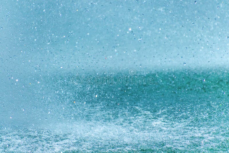 Dynamic Splash Patterns in Cascading Water Drops Against Blue ...