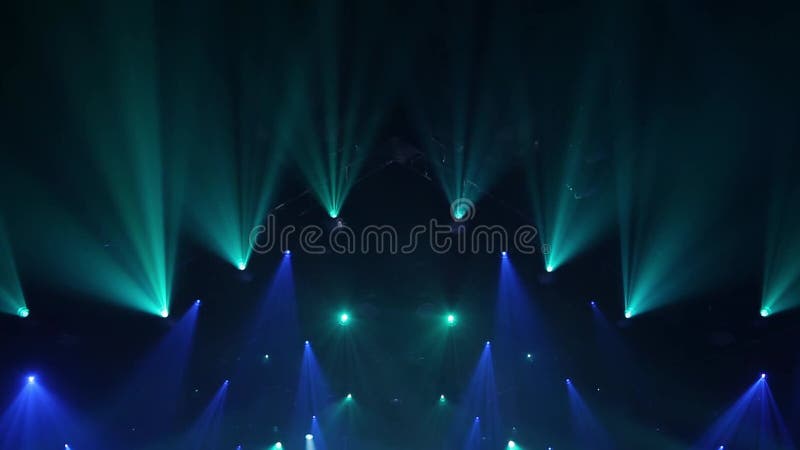 Dynamic Stage Lighting with Rays of Blue Light Cutting through Haze in ...