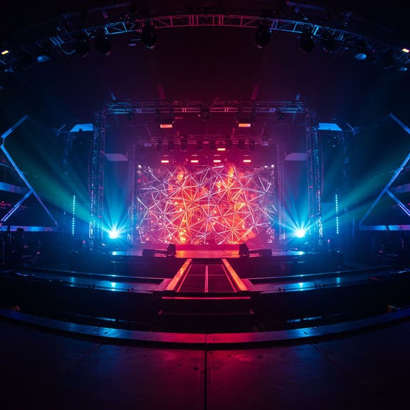 A Dynamic Stage Setup Features a Network of Intersecting Red and Blue ...