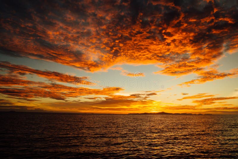 Dynamic sunset at sea stock photo. Image of beach, gold - 76851912