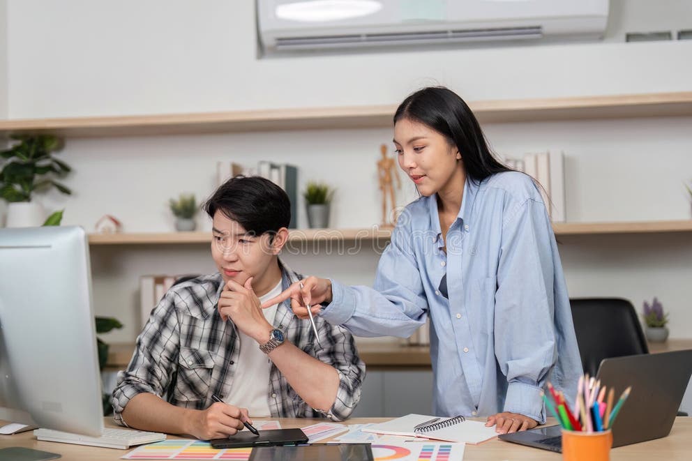 Dynamic UX and UI Design Interaction. Young Professionals Collaborating on Digital Projects in a ...