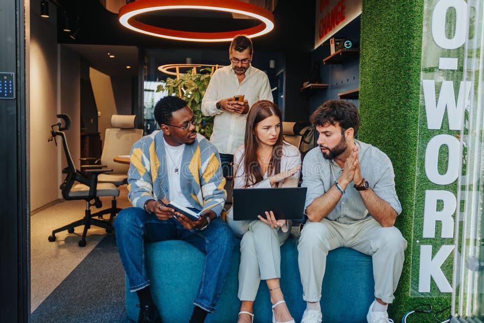 A Diverse Group of Professionals Collaborate in a Co-working Space ...