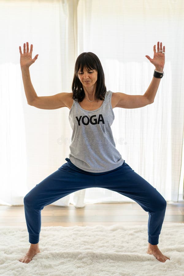 Dynamic Yoga Coach Expressing Strength and Balance in the Goddess Pose ...