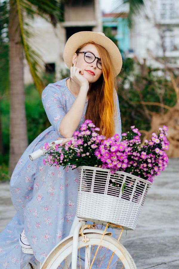 Beautiful Woman in a Blue Dress Riding a Bicycle Immagine Stock ...