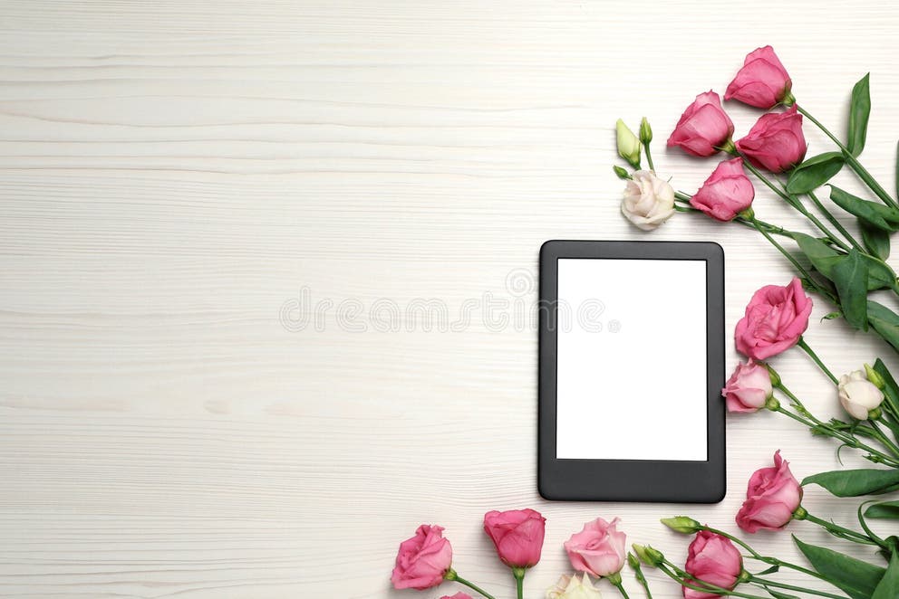 E-book Reader with Flowers on White Wooden Table, Flat Lay. Space for ...