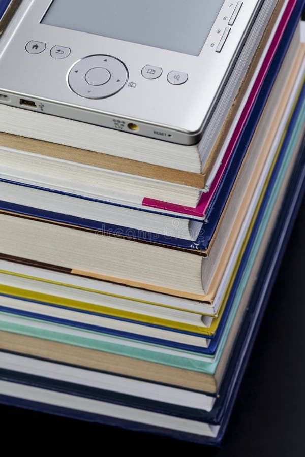 E-book Reader on Top of Stack of Books in a Library Stock Image - Image ...