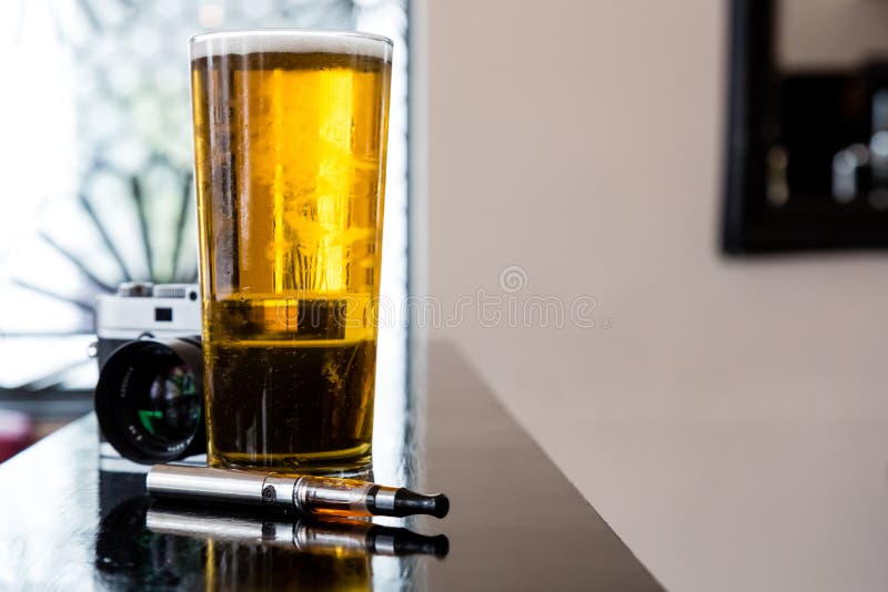 E-cigarette with a Full Pint of Beer and Camera Stock Image - Image of ...