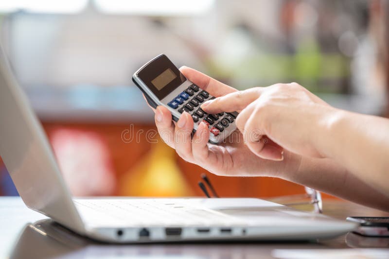 E-commerce Concept. the Hand of the Person Holding the Calculator and ...