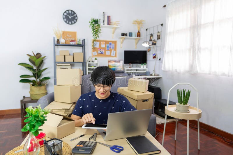 E-commerce Concept a Male Online Merchant Using the Electronic Devices ...