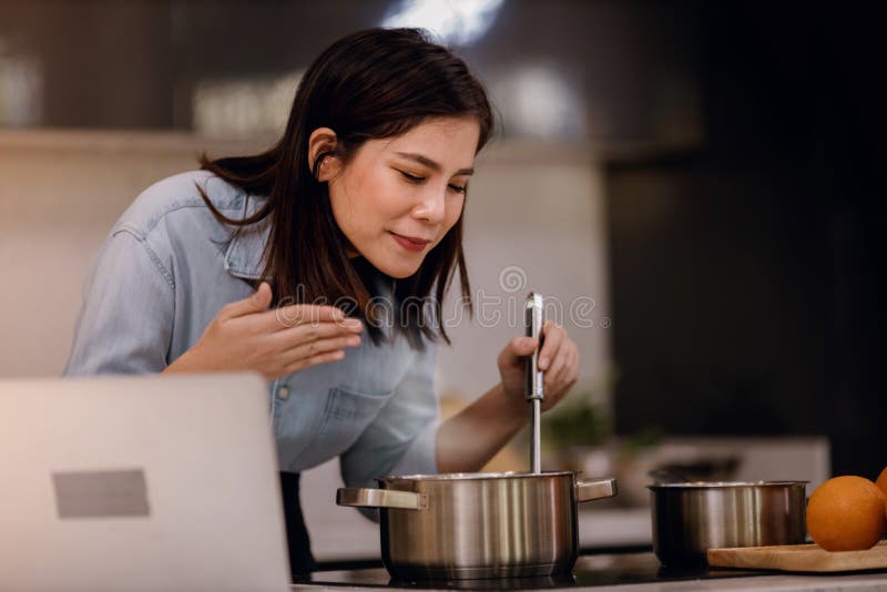 E-Learning Concept. Young Woman Try To Practice and Learn for Cooking ...