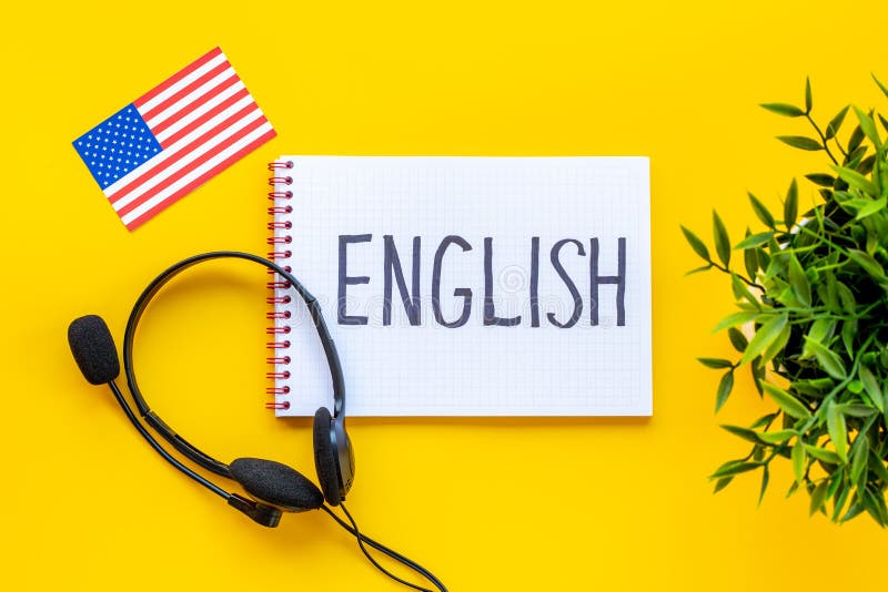 E-learning English Language Courses. Headpones on Student Table Desk ...