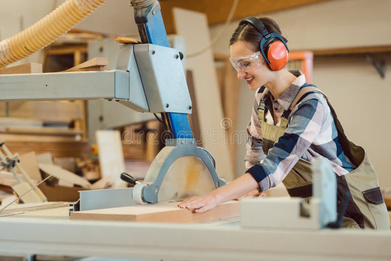 Woman Carpenter Working with Wood at the Table Saw Imagem de Stock ...