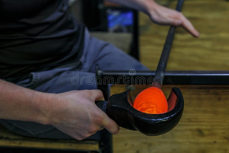 Glass Blower Shaping a Bubble of Melted Glass on a Rod by Hand at a ...