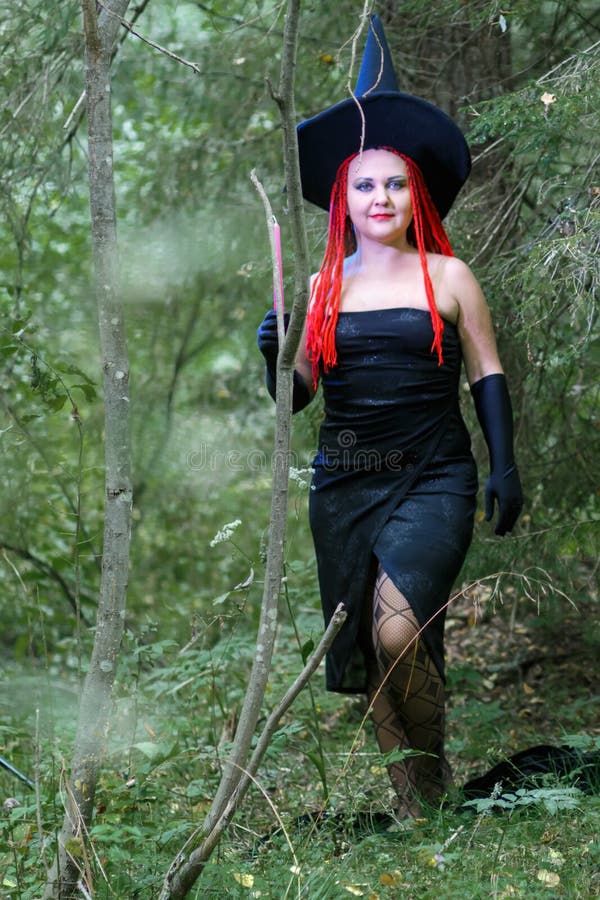 Seductive Witch with Red Hair in the Forest is Engaged in Love Magic ...