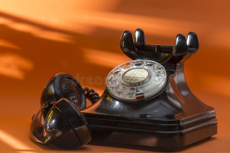 Old Telephone of Black Color, Retro Telephone on Orange Background 库存图片 ...