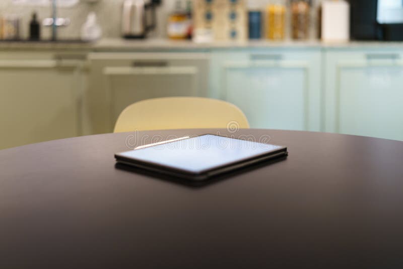 E-reader on Kitchen Table. Graphic Tablet White Screen Mockup Stock ...