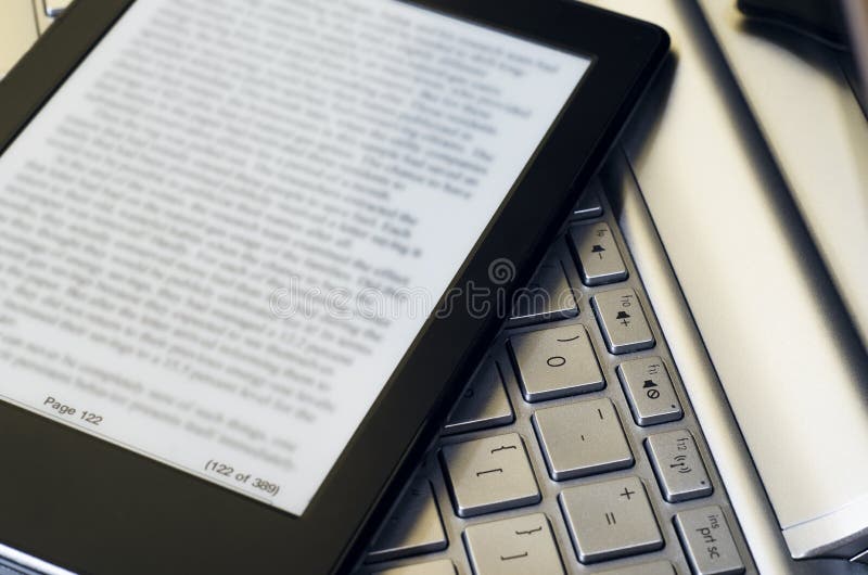 E-Reader Over Laptop Keyboard Stock Image - Image of reader, newspaper ...