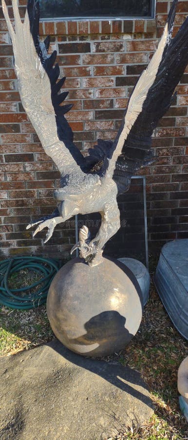 Eagle Statue Catching a Fish on a Globe Stock Photo - Image of catching ...