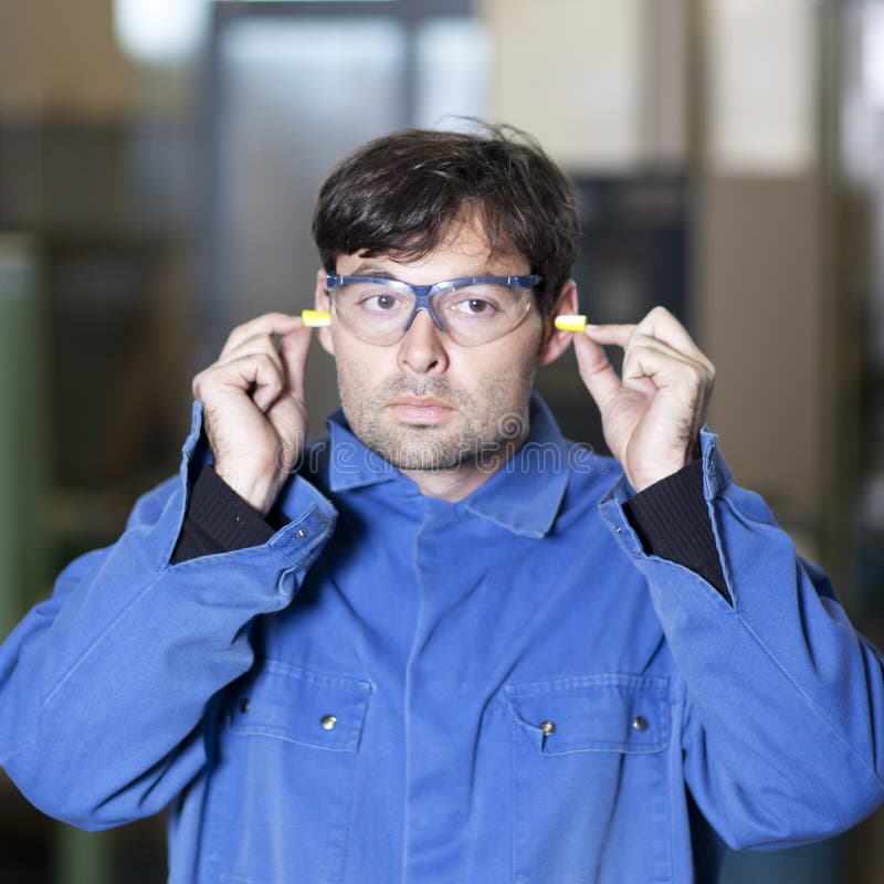 Ear protection at work stock image. Image of touching - 25759581