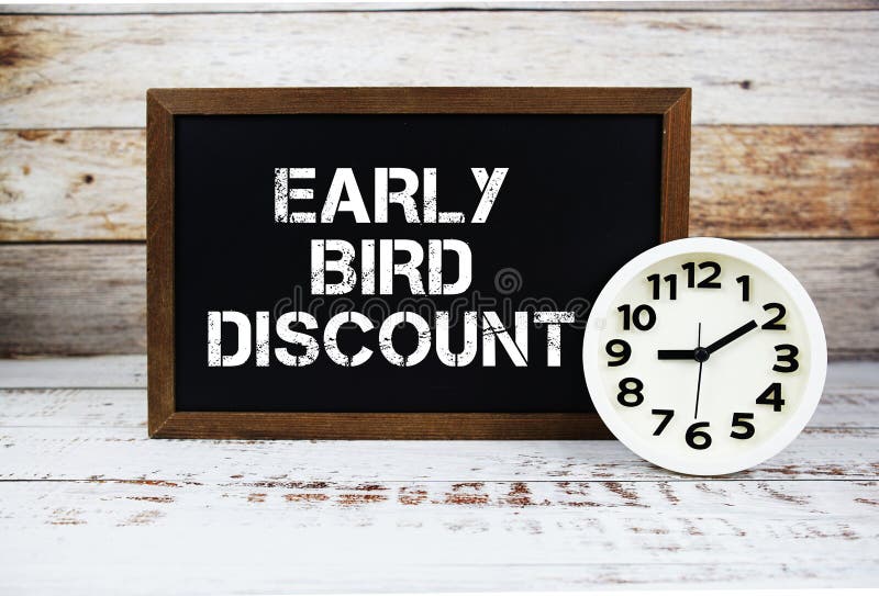 Early Bird Discount Text Message and Alarm Clock on Wooden Background ...