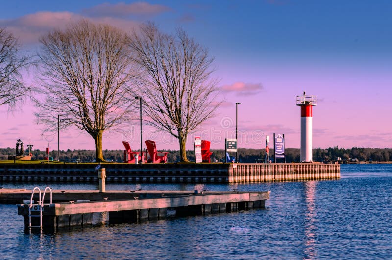 Early Evening View of Empty Boat Slips and a Lighthouse Beacon Stock ...