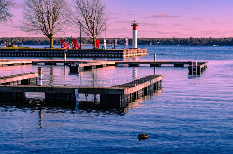Early Evening View of Empty Boat Slips and a Lighthouse Beacon Stock ...