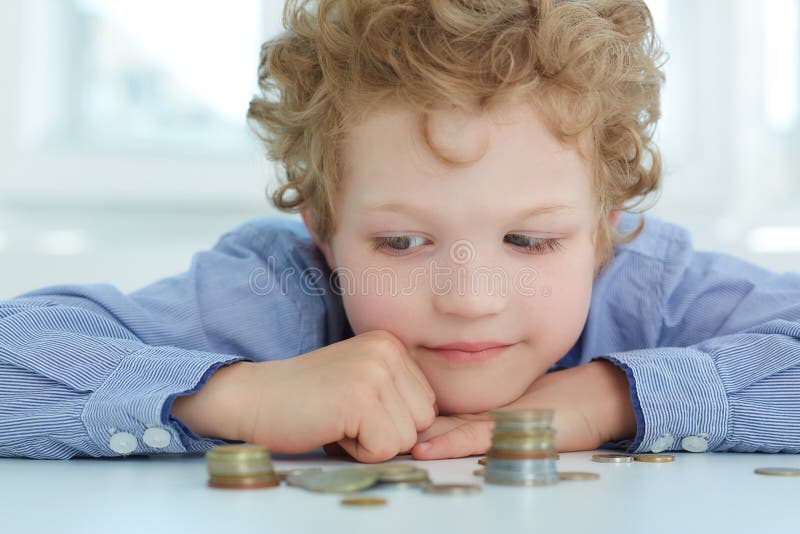 Early Financial Education Concept. Boy Looking at a Stack of Coins ...